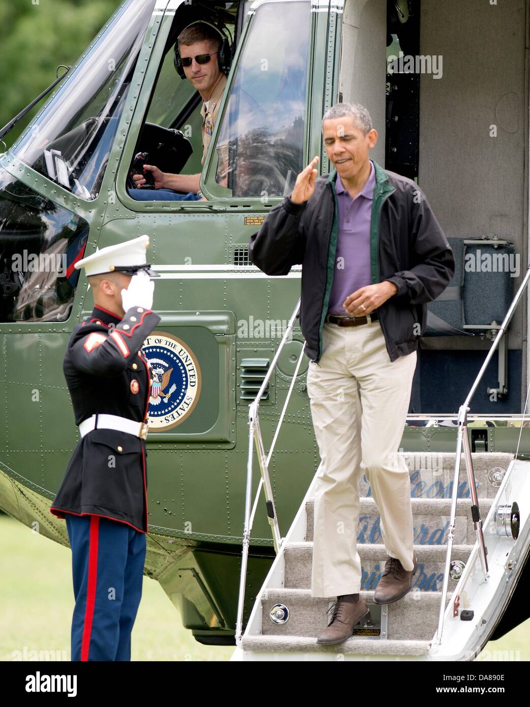 United States President Barack Obama salutes the Marine Guard as he ...