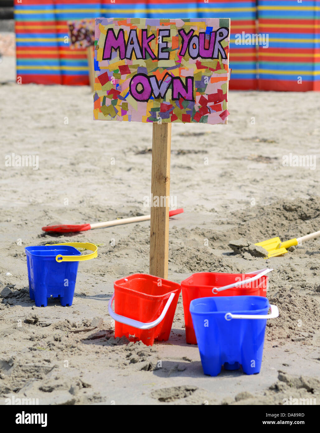 "Make your own" sign next to buckets and spades on the beach Stock ...