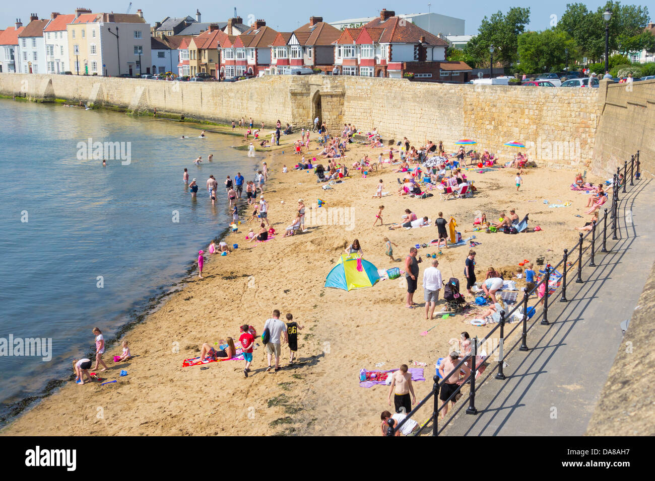 Holidaymakers on the beach by the old medieval sea wall at Hartlepool ...