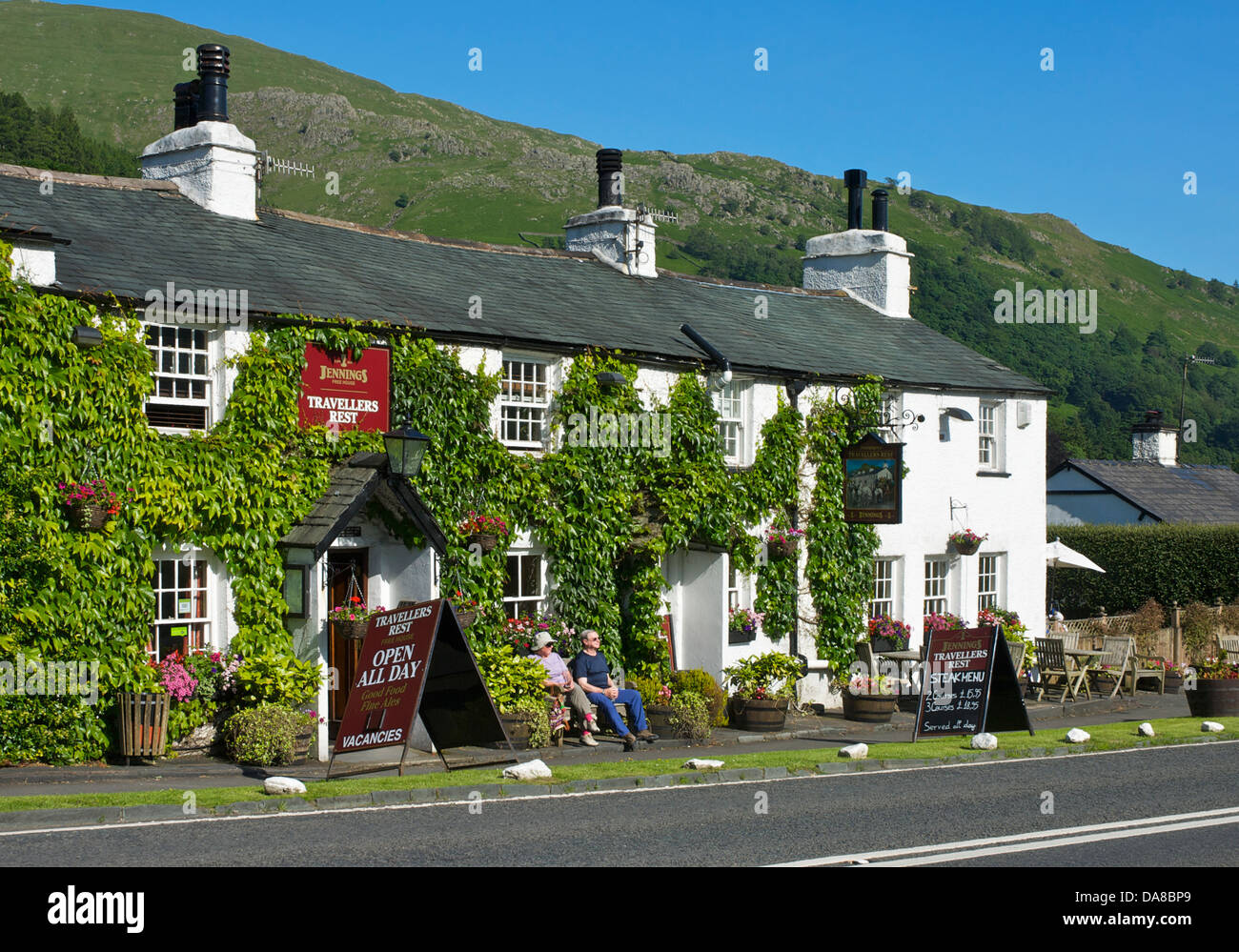 Couple sitting outside the Travellers Rest pub, near Grasmere, Lake ...