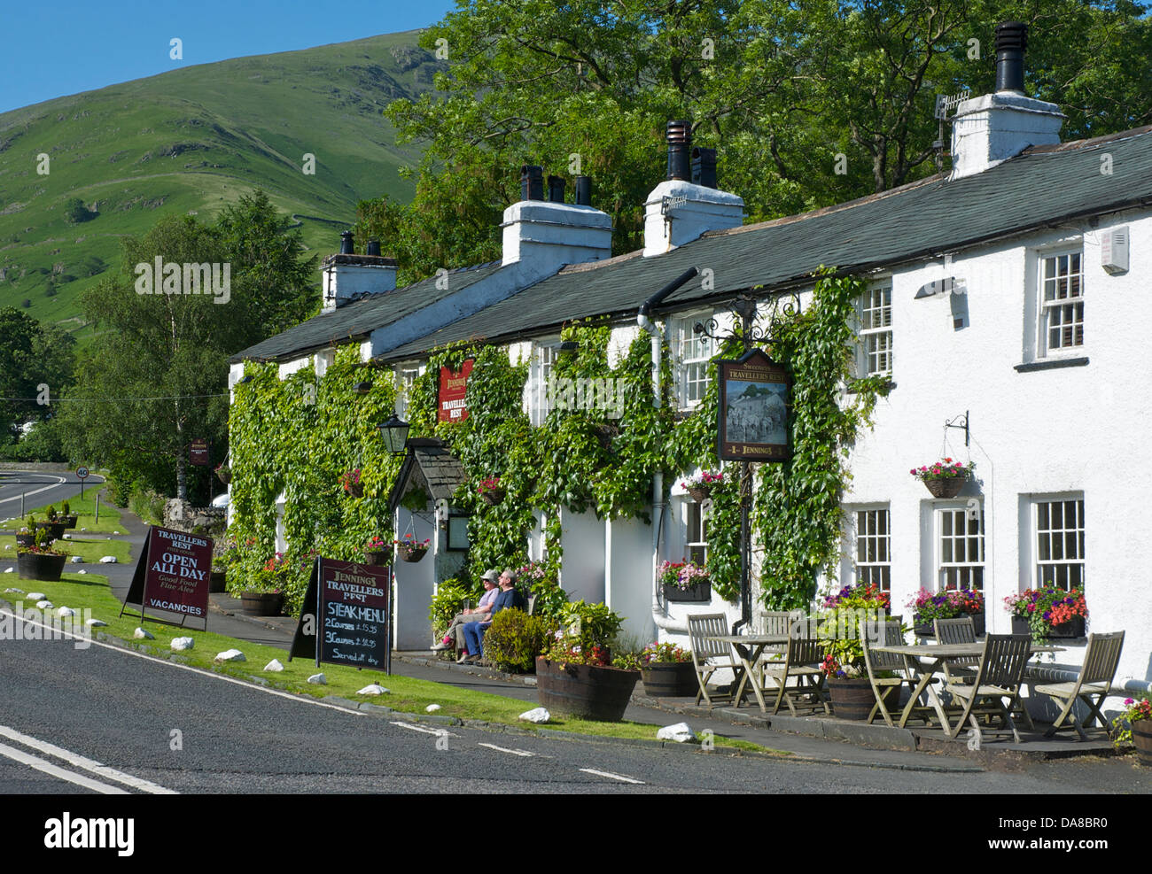 Couple sitting outside the Travellers Rest pub, near Grasmere, Lake ...