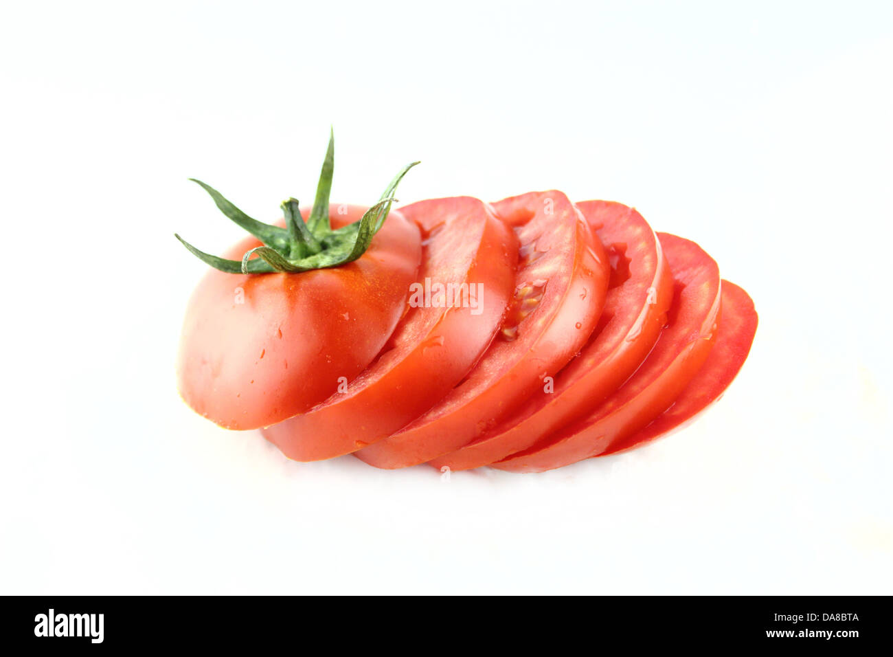 Whole and slices of tomatoes Cut Out Stock Images & Pictures - Alamy