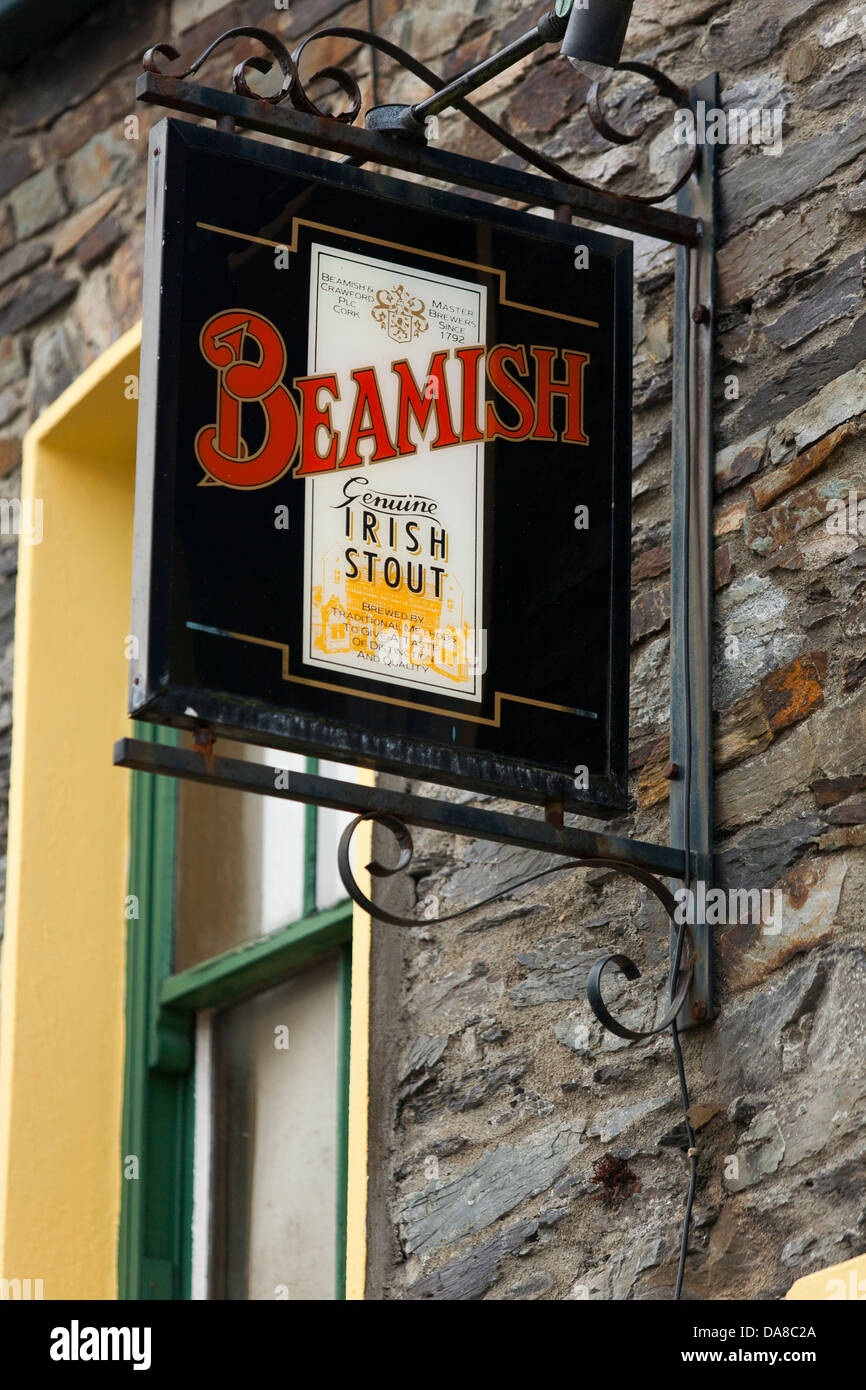 A sign on the outside of a pub advertises Beamish stout in an Irish ...