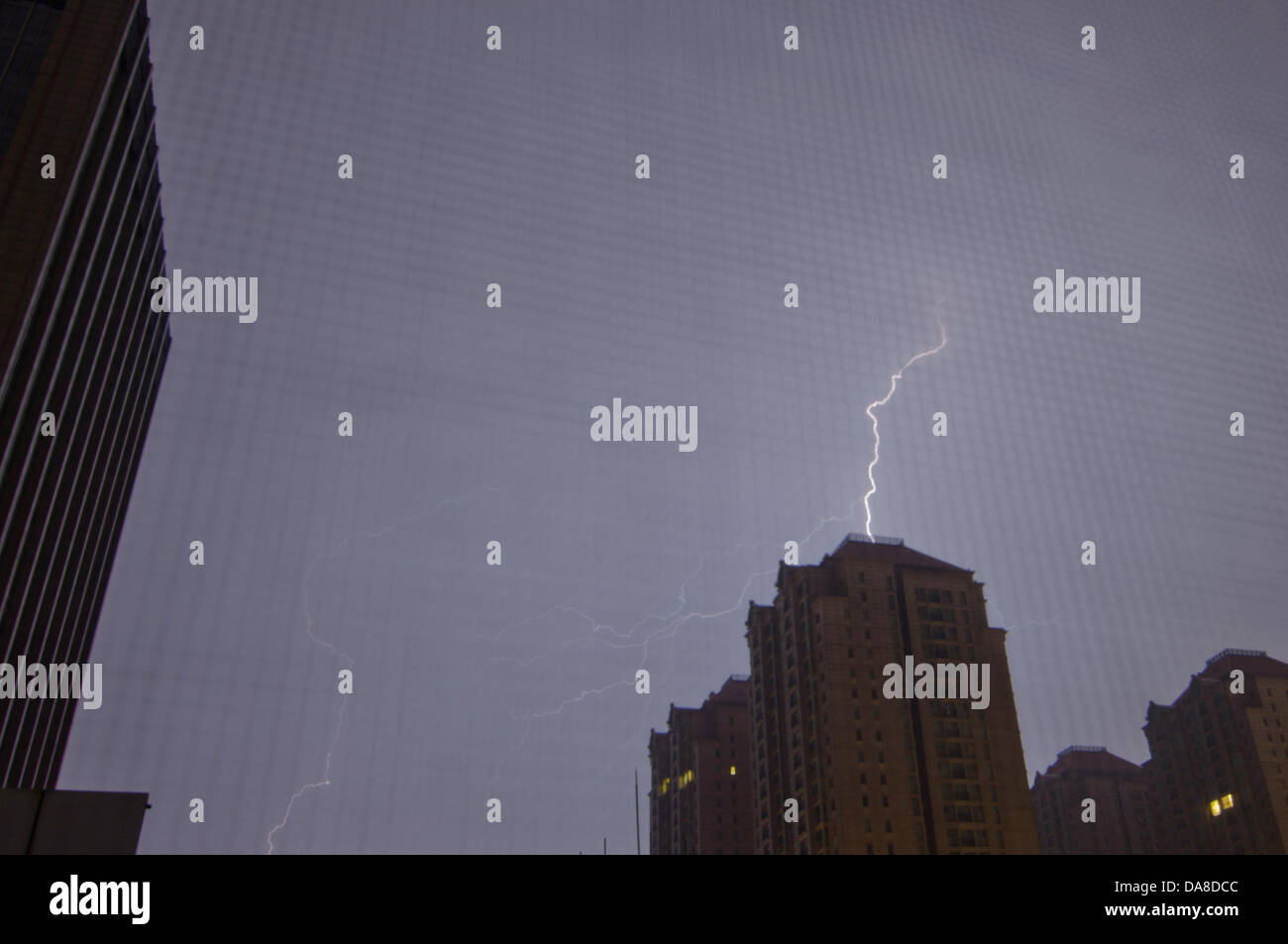 Lightning bolts criss cross the sky during a thunderstorm at night ...