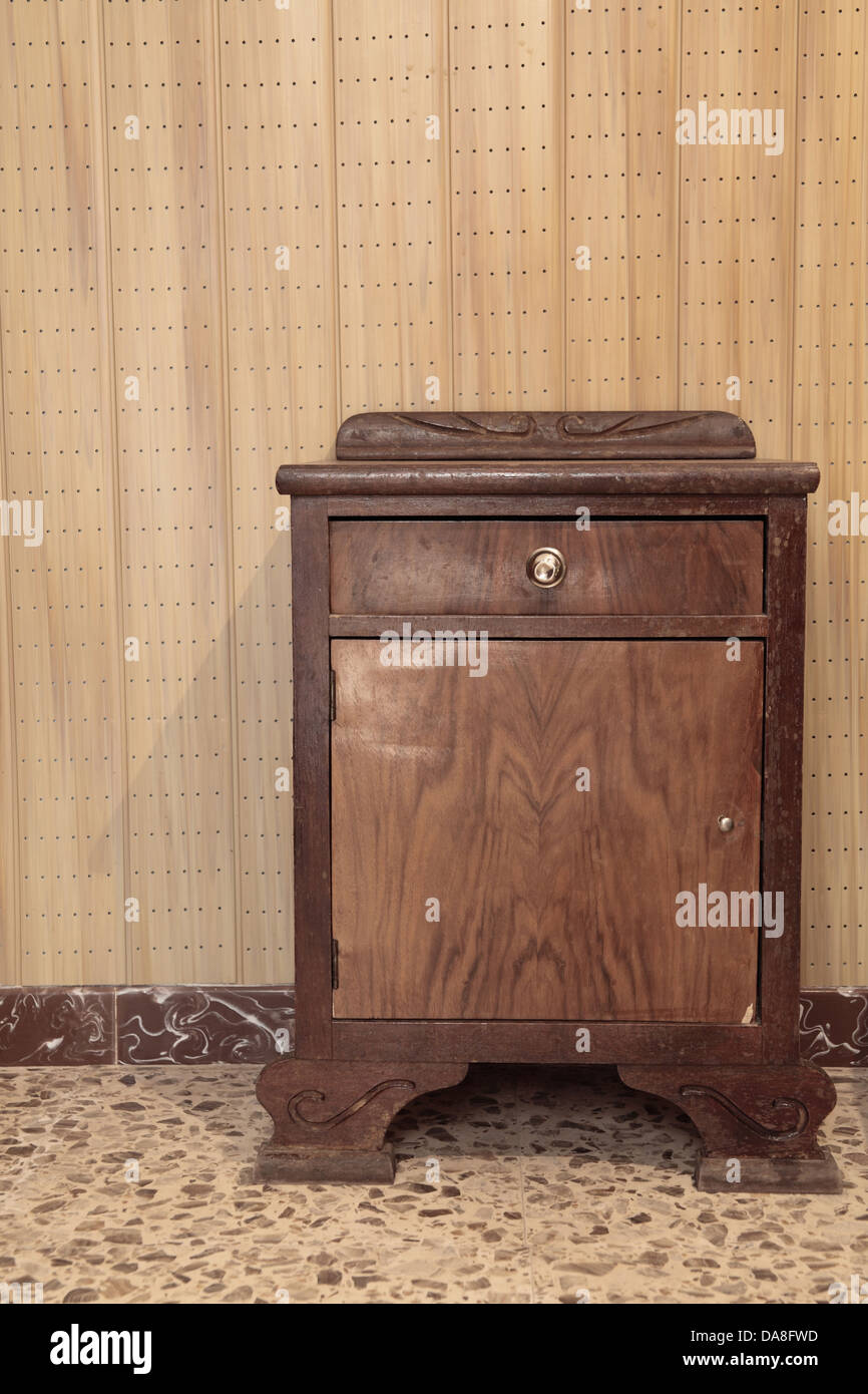 a very old nightstand with a vintage floor and wall Stock Photo - Alamy