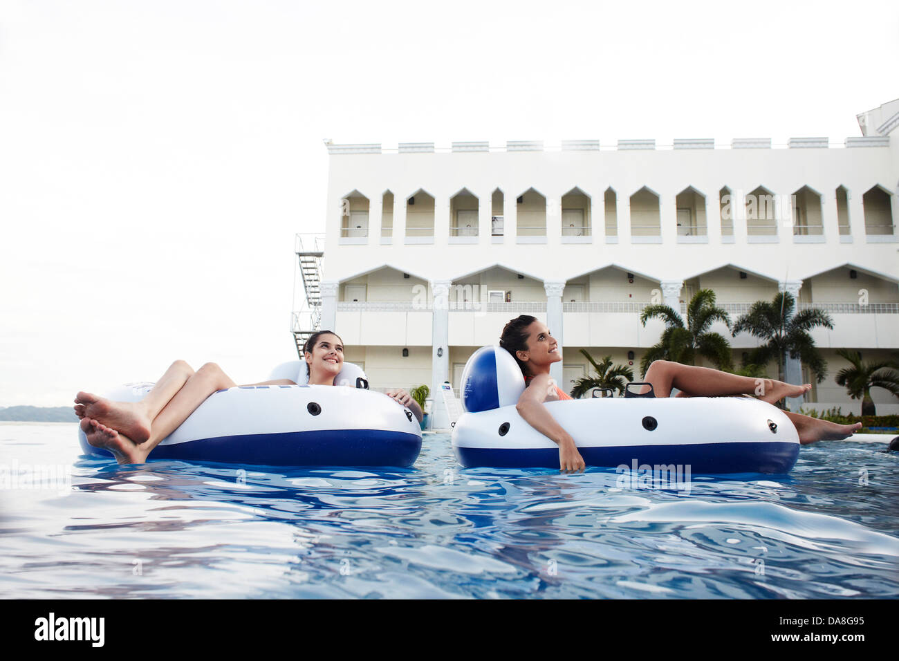 Friends playing in a swimming pool Stock Photo - Alamy