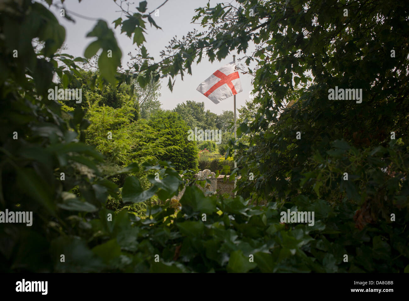 The English flag flies in the churchyard of St Dunstan church, West ...