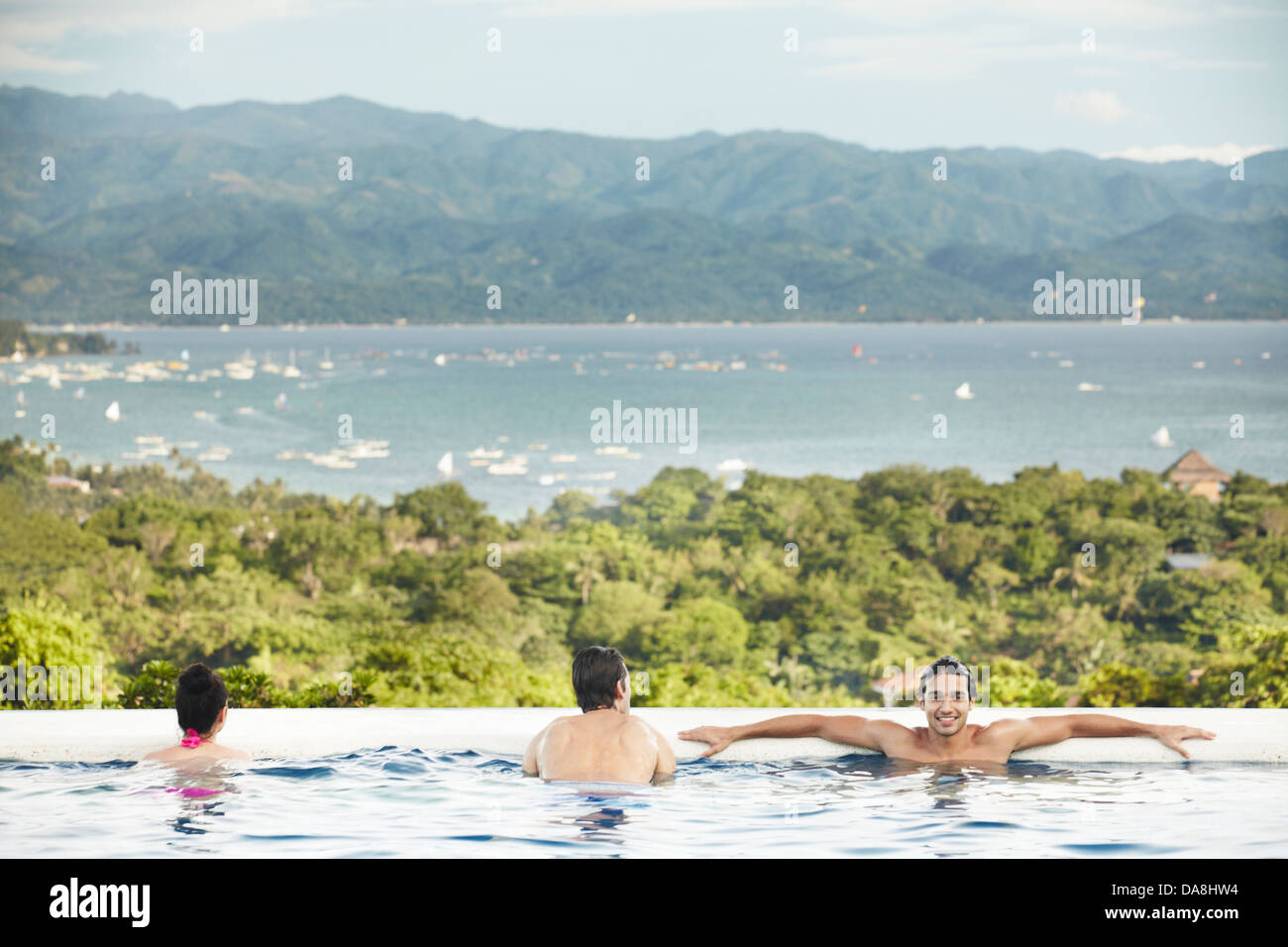 Friends relaxing poolside Stock Photo - Alamy