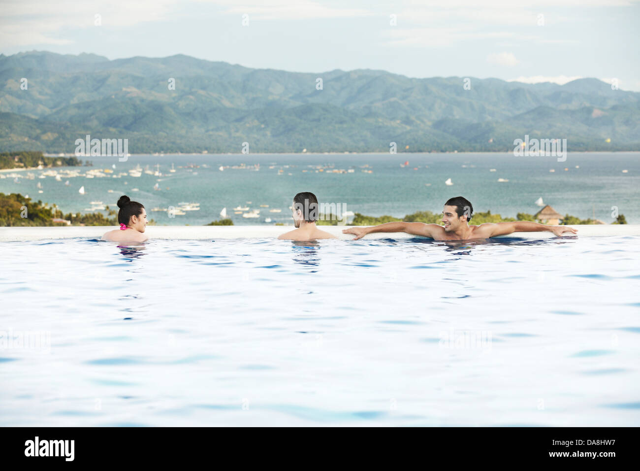 Friends relaxing poolside Stock Photo - Alamy