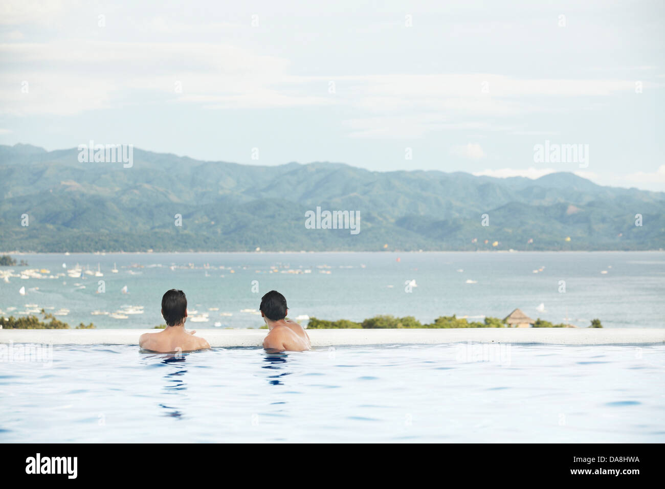 Friends relaxing poolside Stock Photo - Alamy
