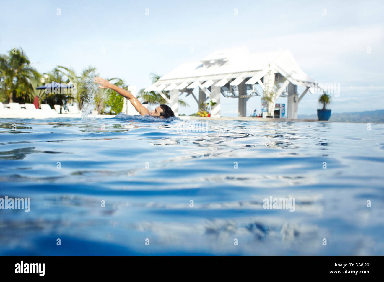 Friends playing in a swimming pool Stock Photo - Alamy