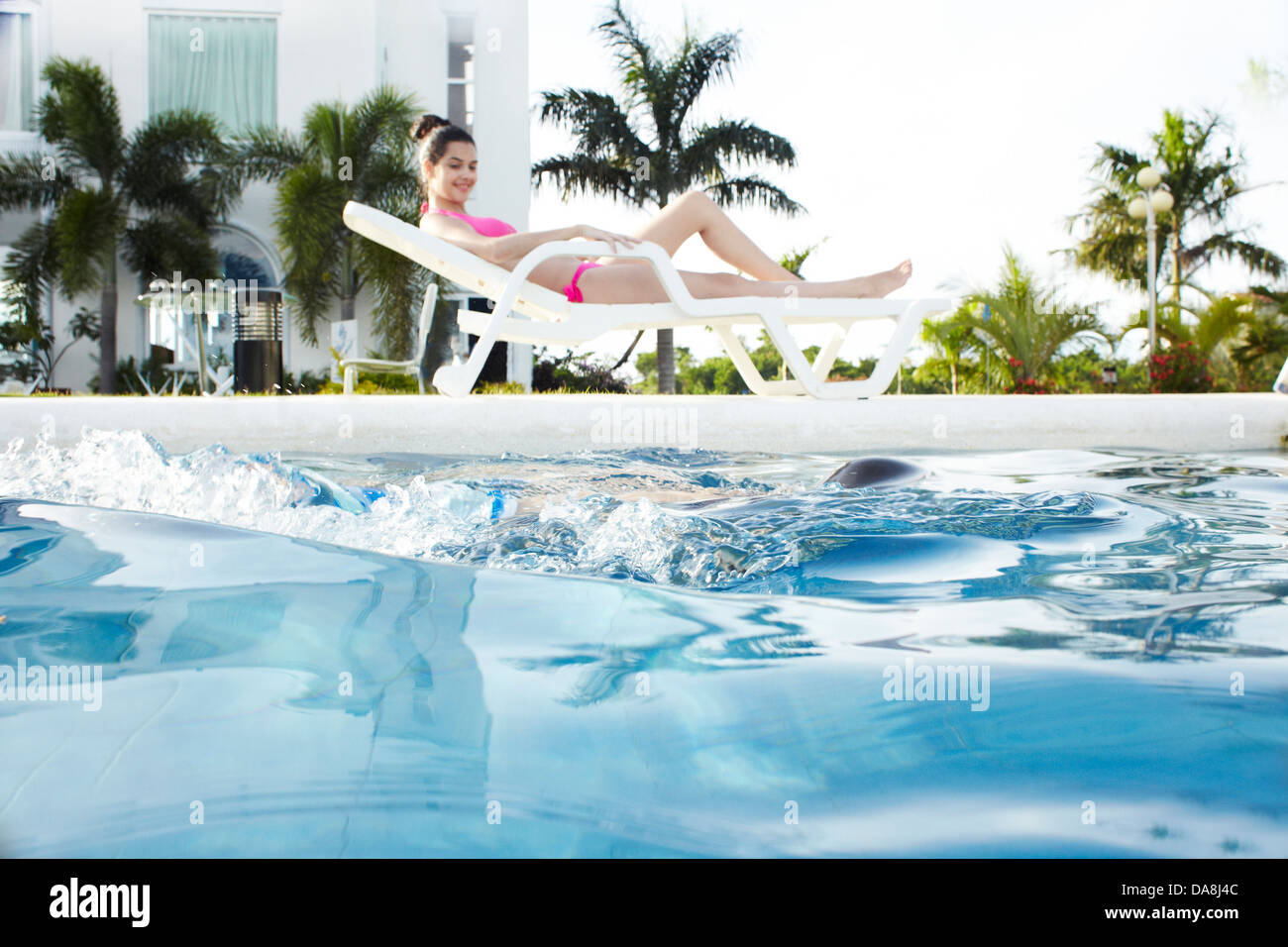 Friends relaxing poolside Stock Photo - Alamy