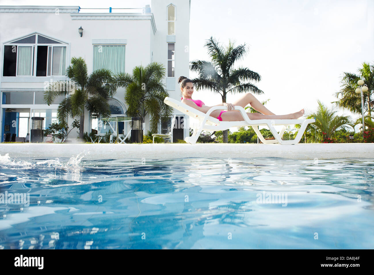 Friends relaxing poolside Stock Photo - Alamy