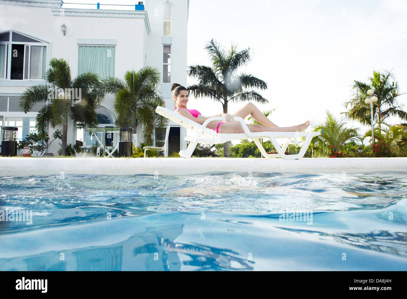 Friends relaxing poolside Stock Photo - Alamy