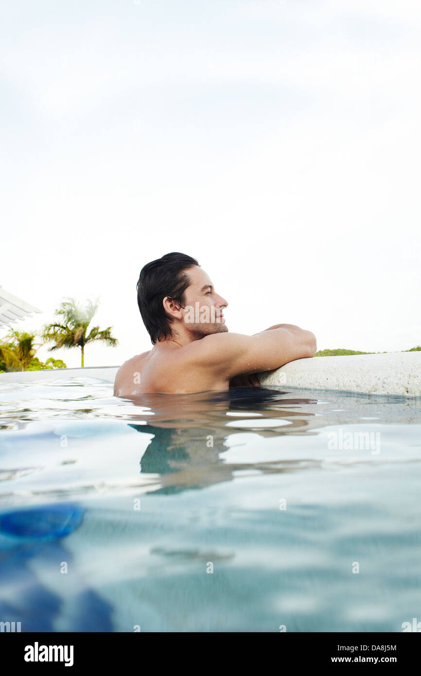 A man relaxing in a swimming pool Stock Photo - Alamy
