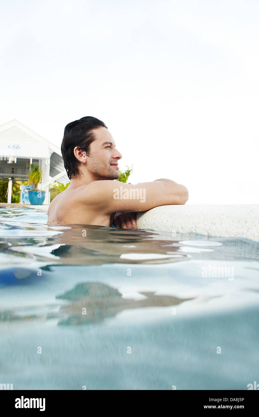 A man relaxing in a swimming pool Stock Photo - Alamy