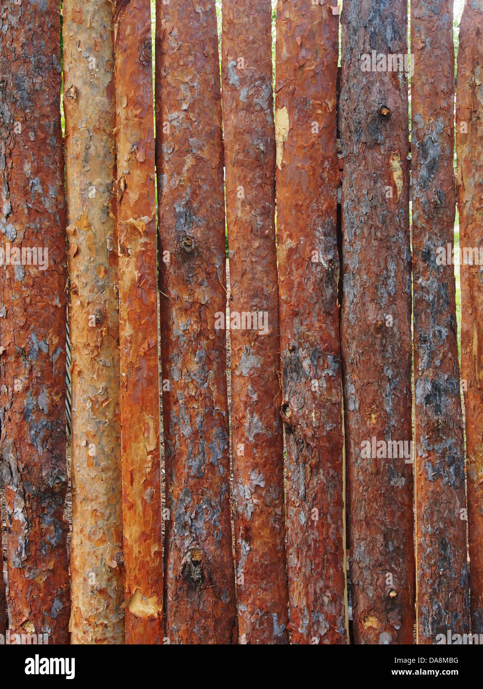 Wooden bark fence wall background, vertical Stock Photo - Alamy