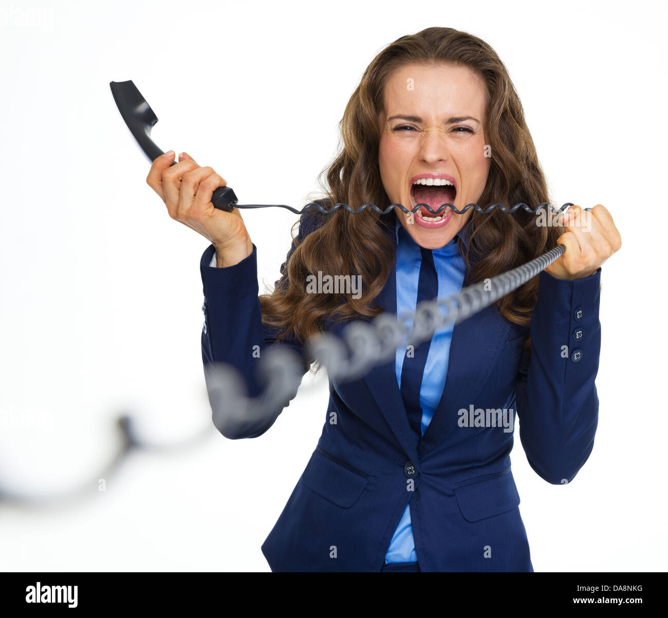 Angry business woman biting phone cord Stock Photo - Alamy