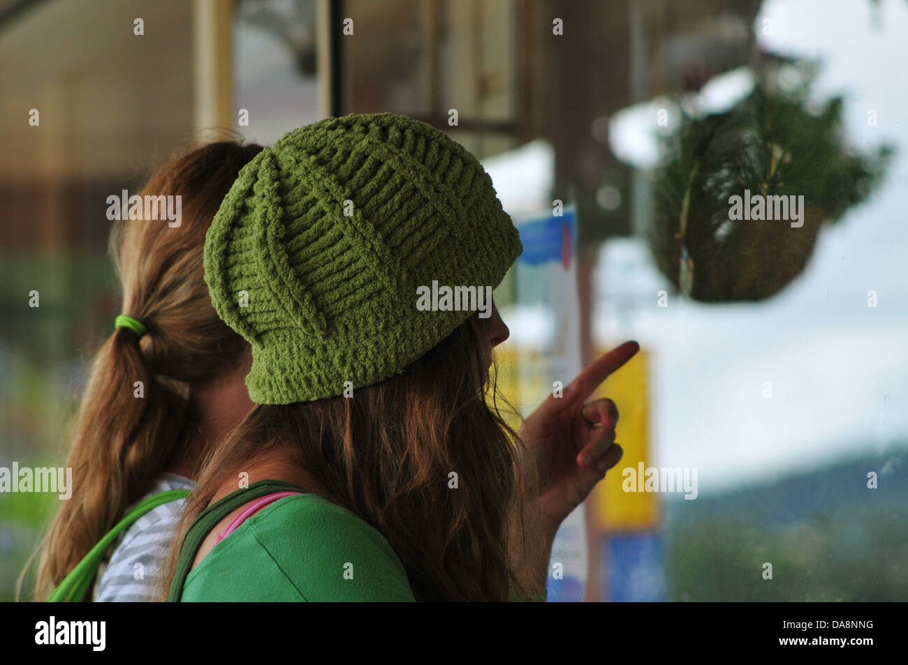 Two young women in front of store window Stock Photo - Alamy