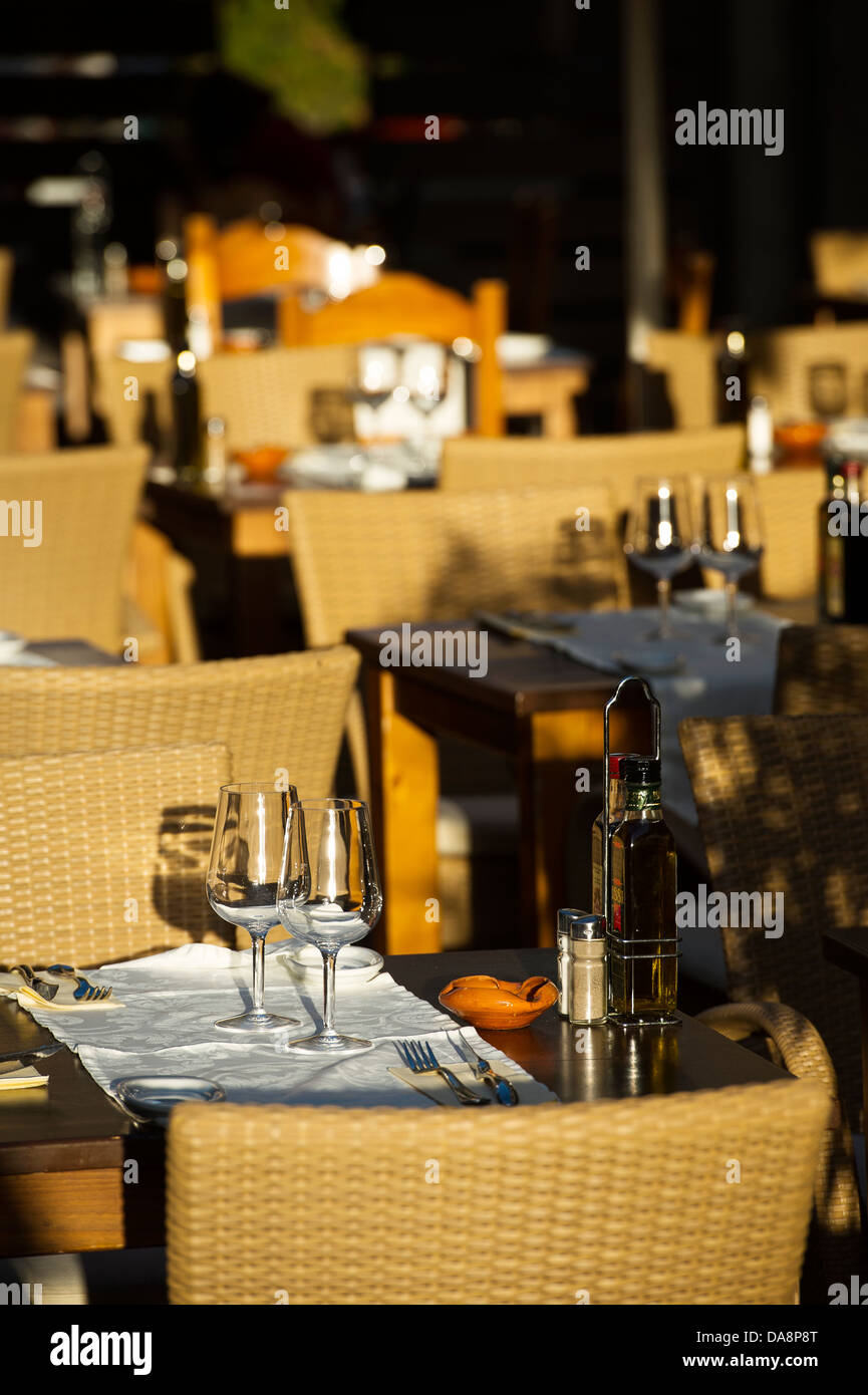 Empty tables and chairs outside a bar in the Old Town area of Alcudia ...