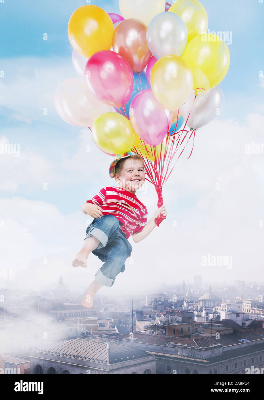 Funny image presenting child flying by the balloons Stock Photo - Alamy
