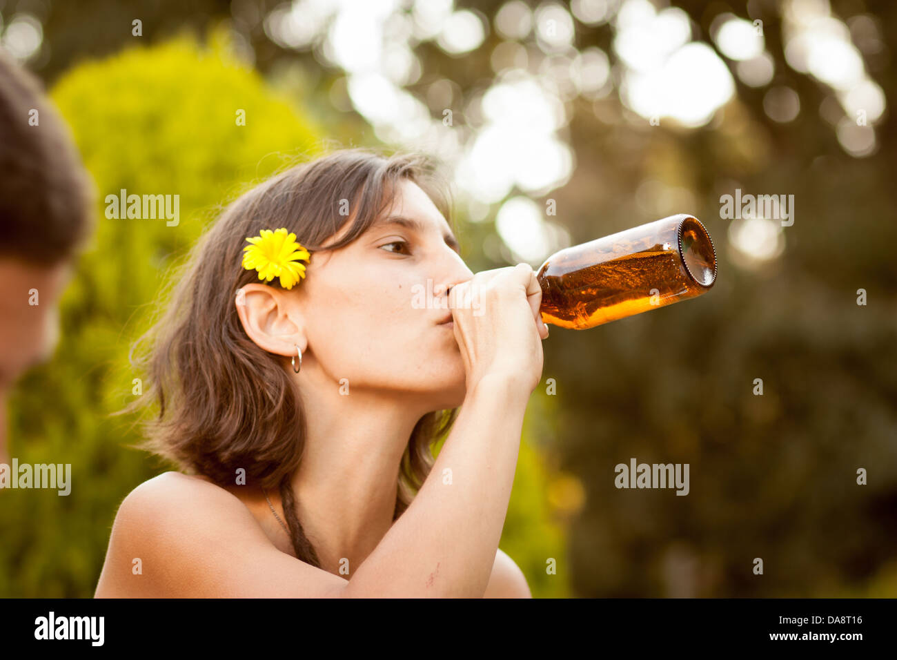 Beautiful young woman drinking beer in a terrace Stock Photo - Alamy