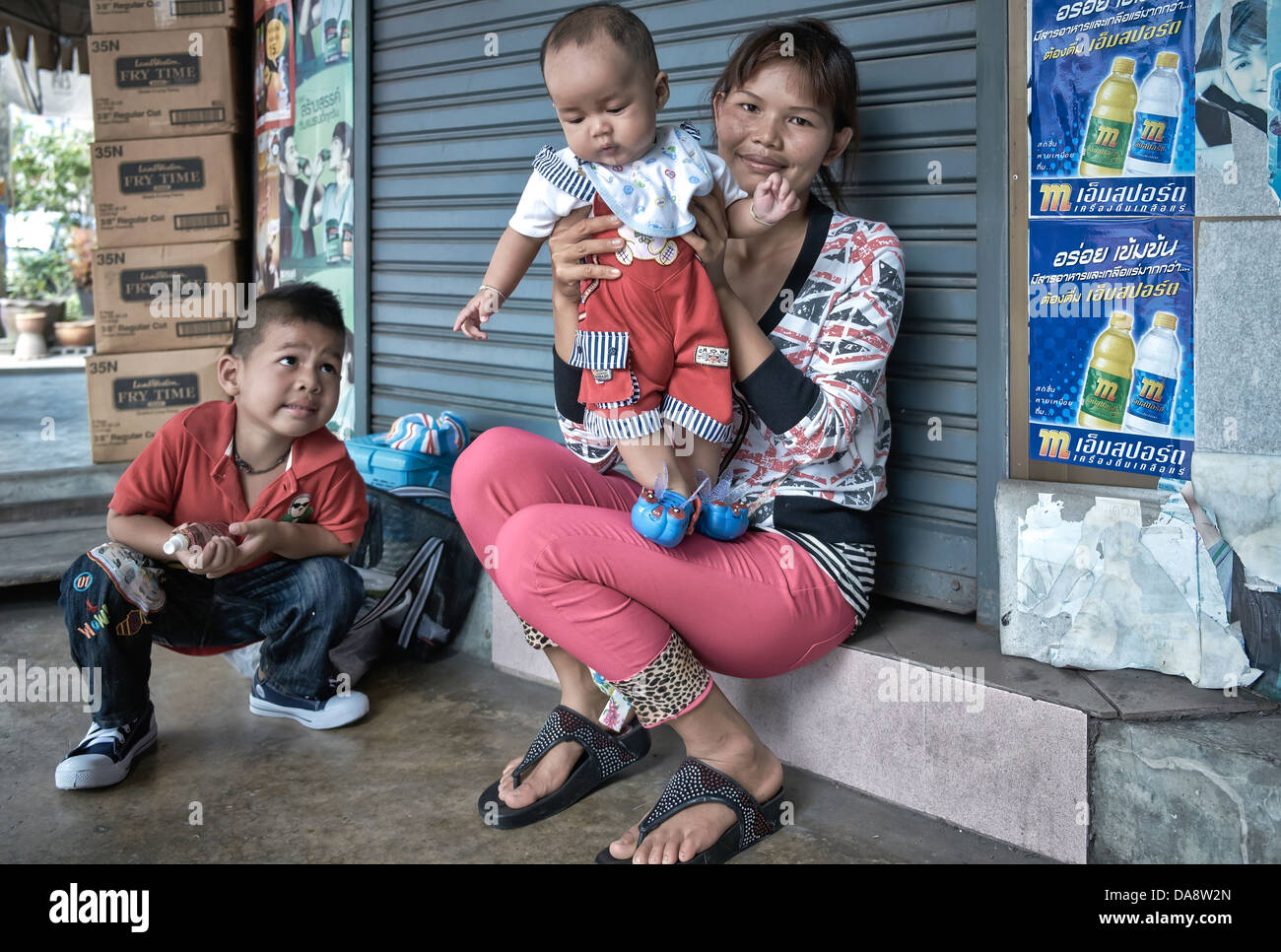 Thailand family. Young Thai mother with infant child and onlooking ...