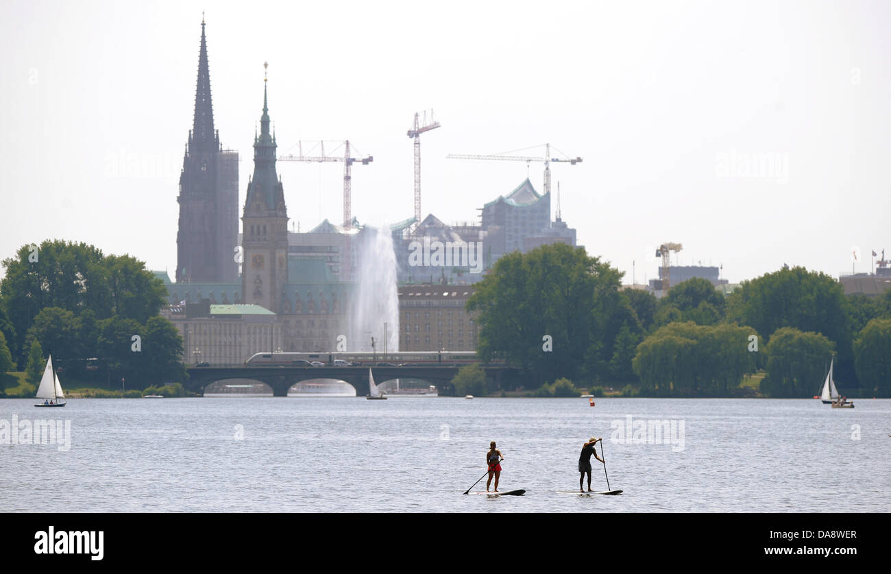 Two stand up paddlers are pictured on the Outer Alster Lake in front of ...