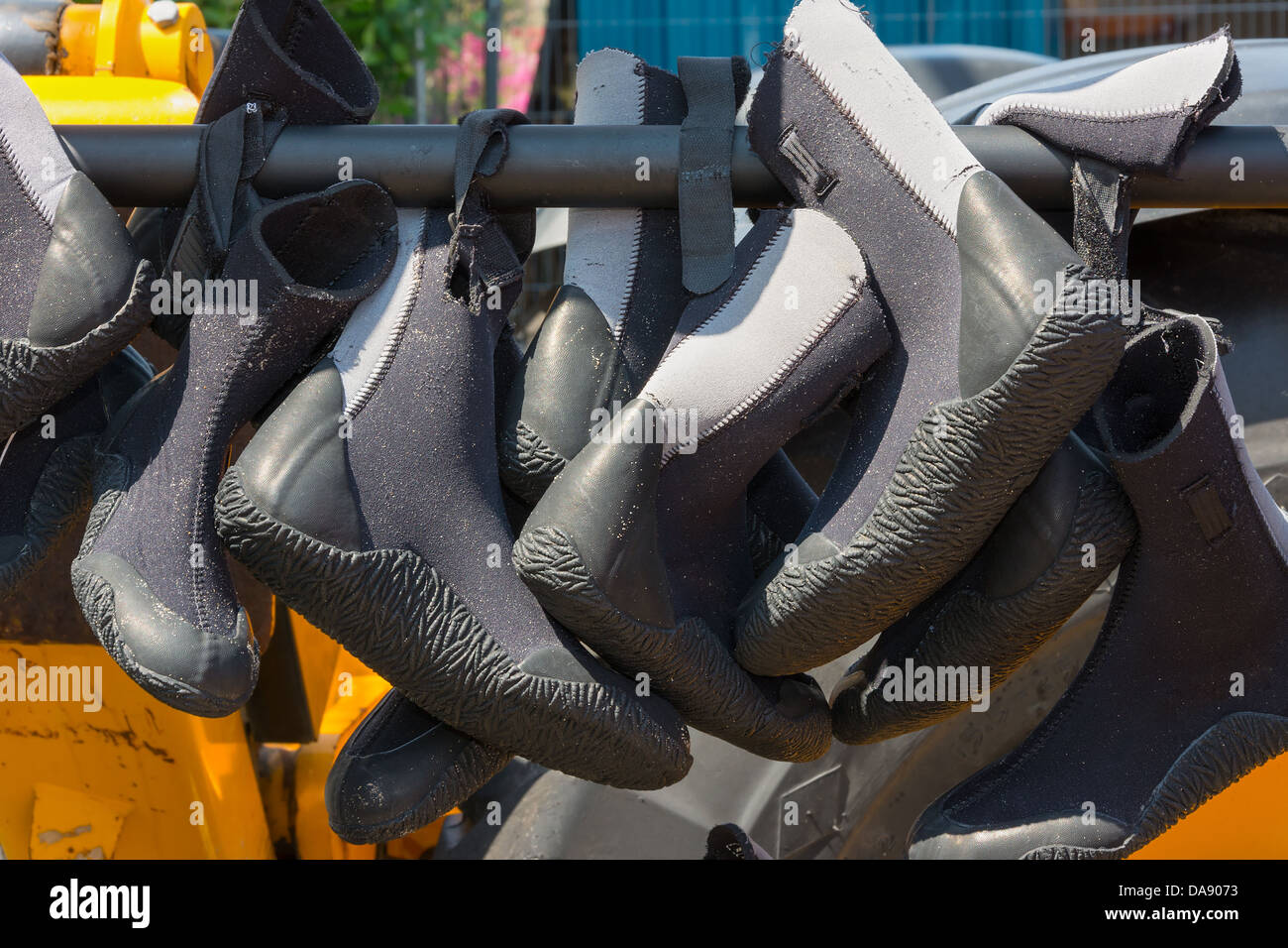 Rack of rubber boots drying off after use Stock Photo - Alamy