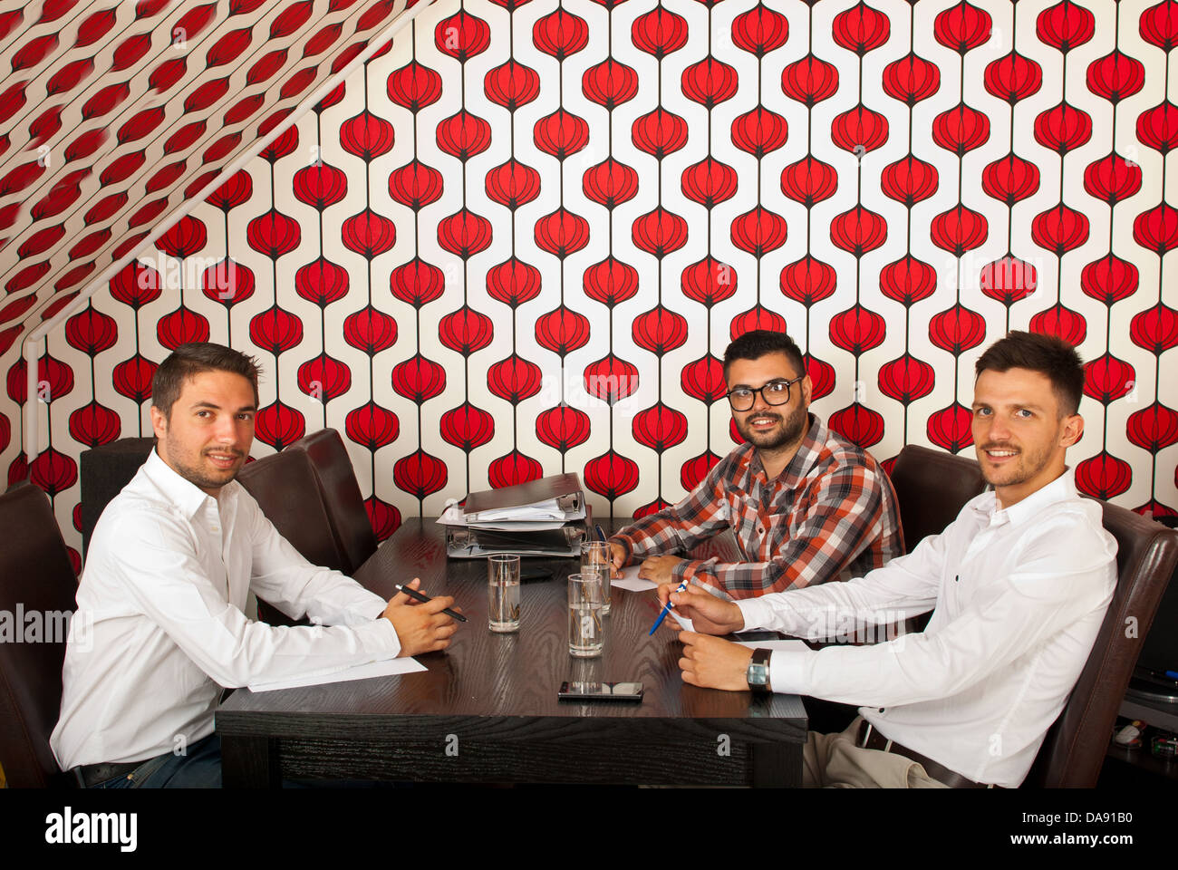 Cheerful business men at meeting in a modern office Stock Photo - Alamy