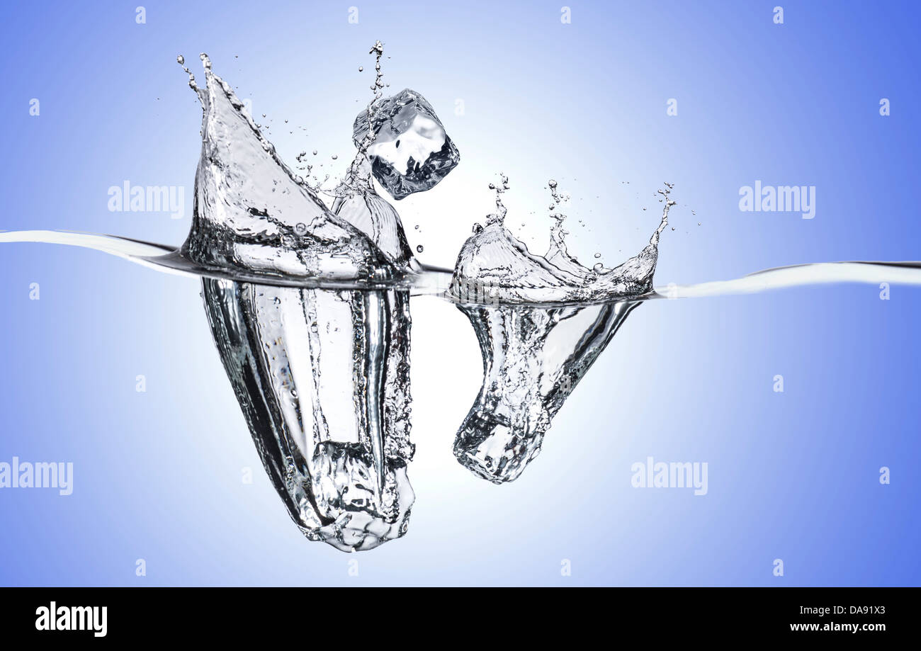 Ice Cubes Splashing In To Water Stock Photo - Alamy