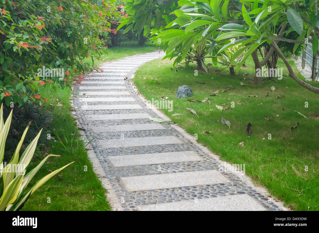 Bending garden stone path Stock Photo - Alamy