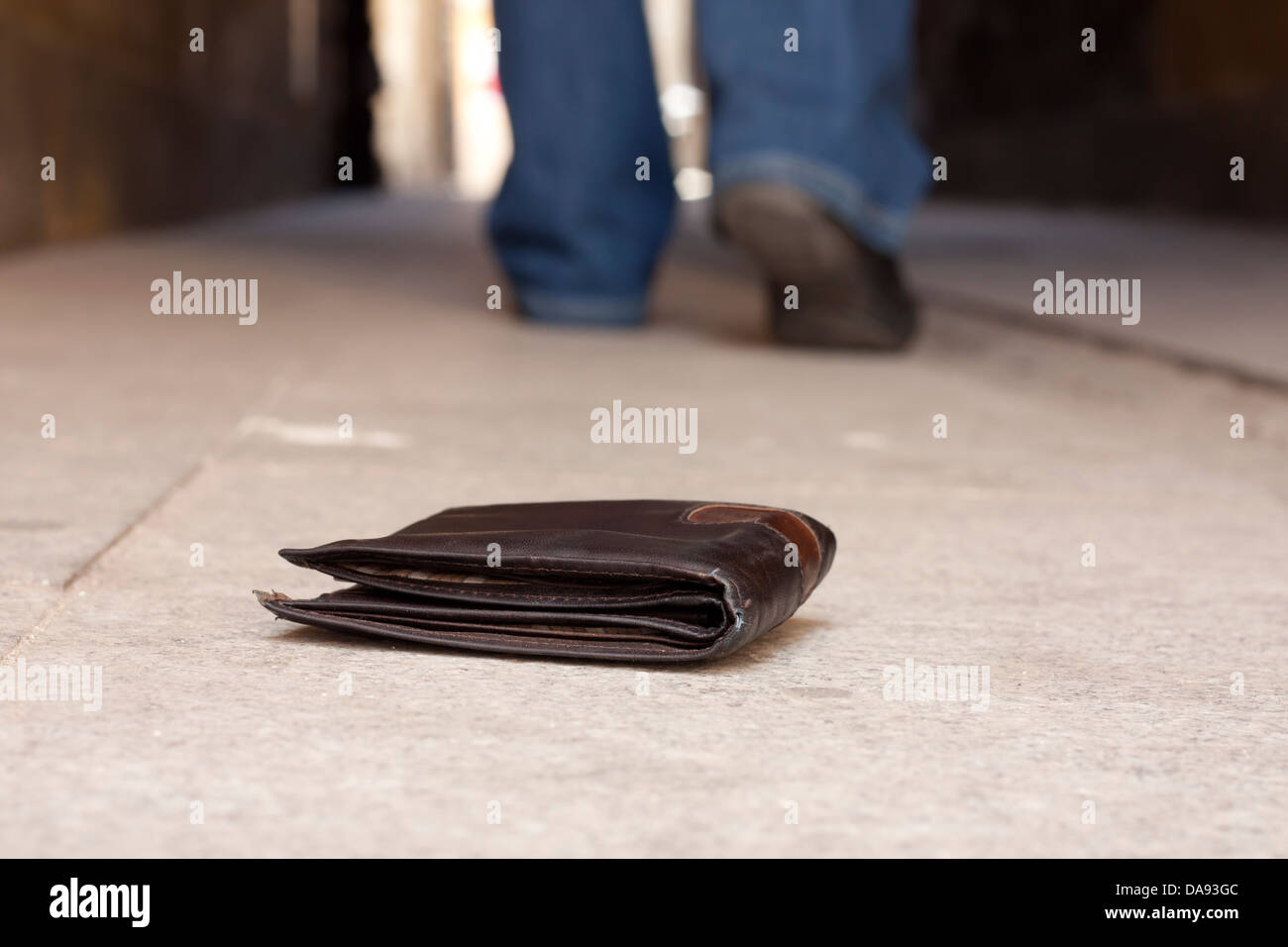 Lost wallet on the street and legs of the walking man concept Stock ...