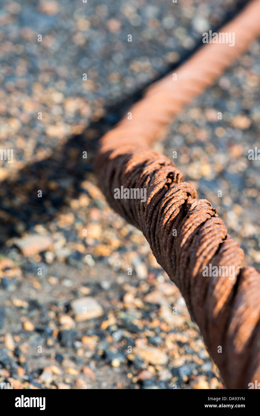 rusty cable coming out of the ground Stock Photo - Alamy