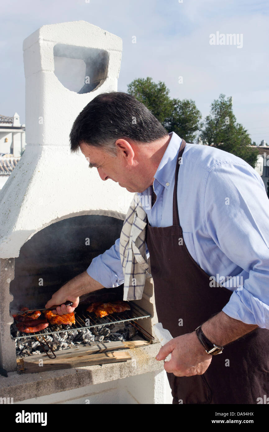 Man cooking on barbeque Stock Photo - Alamy