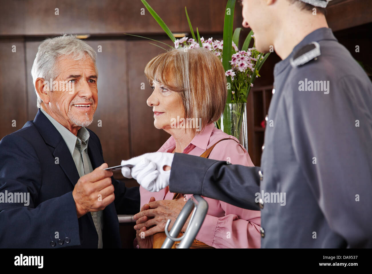 Senior people taking key card from concierge in a hotel Stock Photo - Alamy