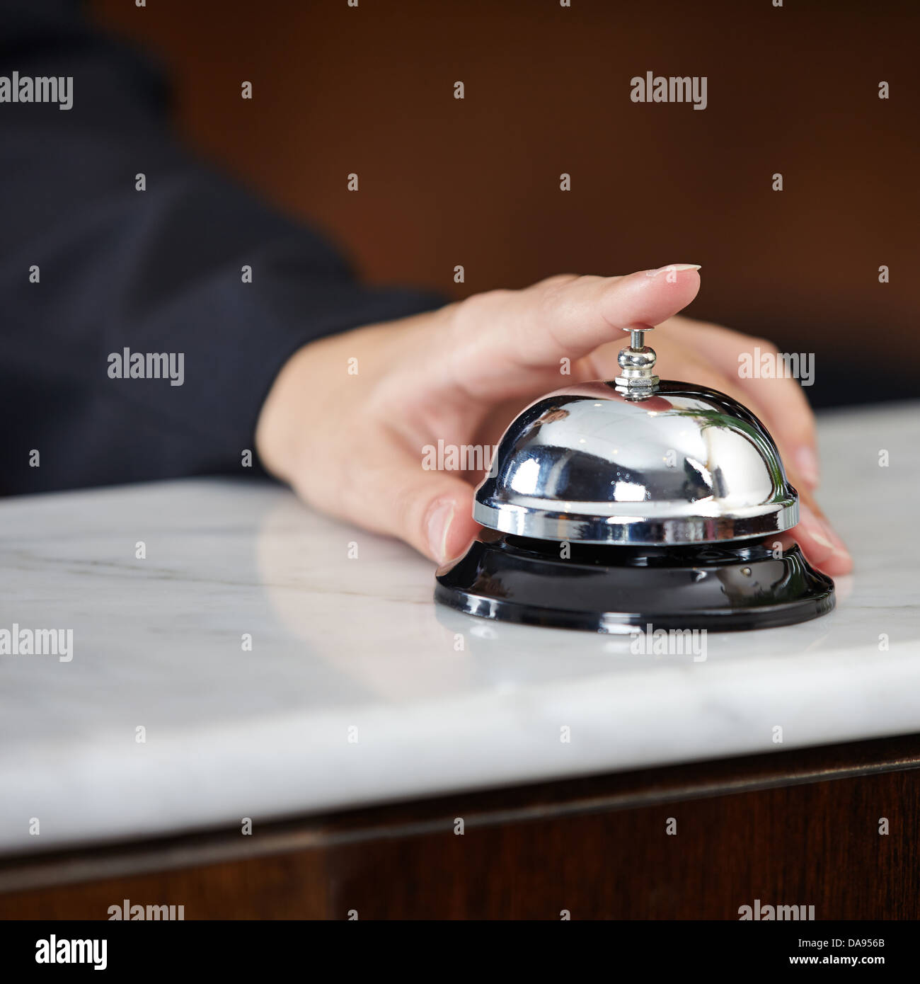 Female hand ringing hotel bell at the counter with index finger Stock ...