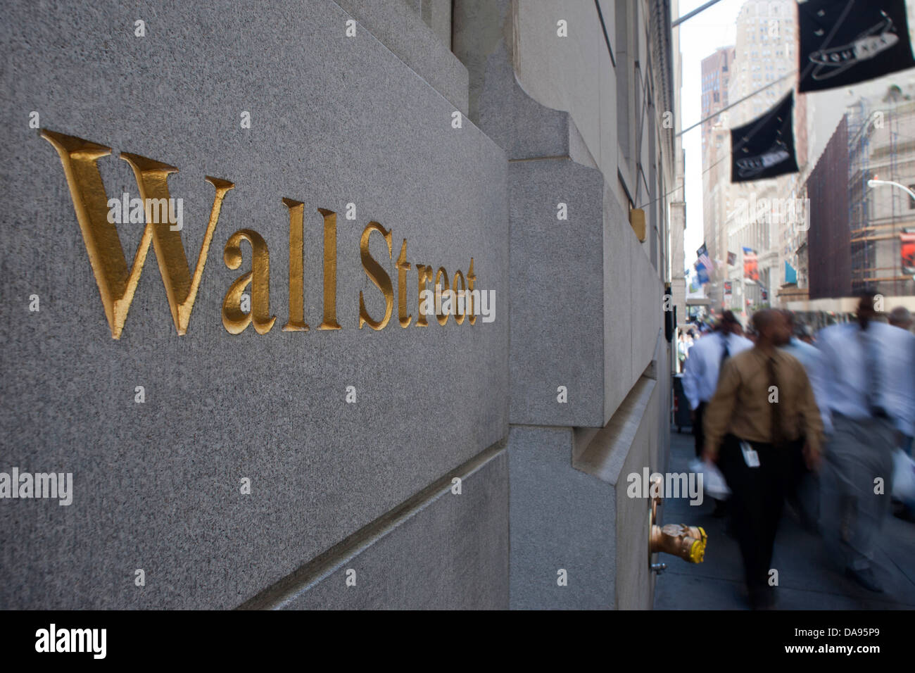 PEOPLE WALKING PAST WALL STREET SIGN DOWNTOWN MANHATTAN NEW YORK USA ...