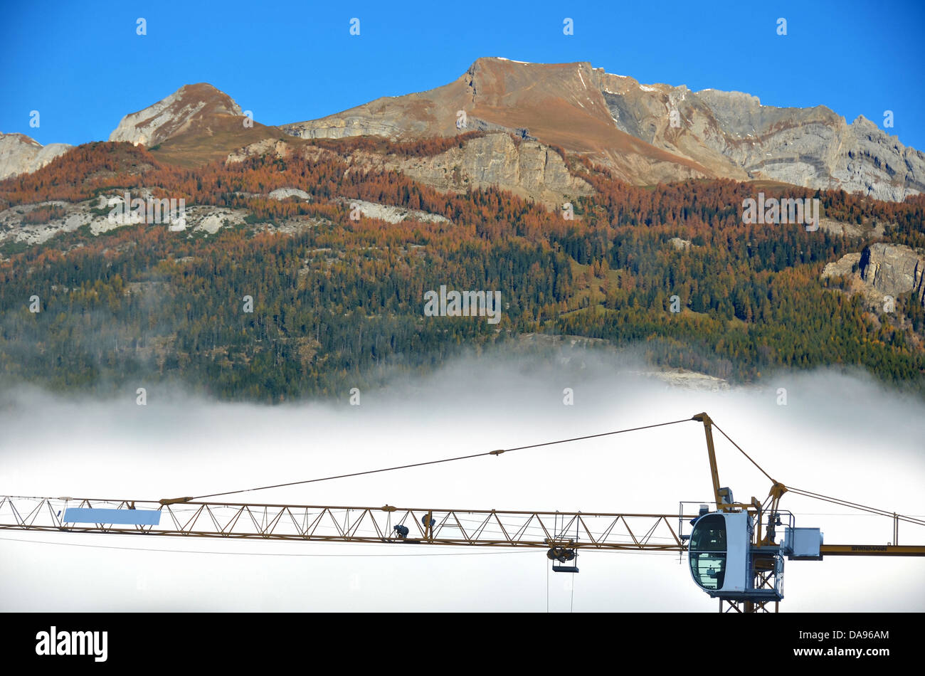 Crane building against backdrop mountains hi-res stock photography and ...