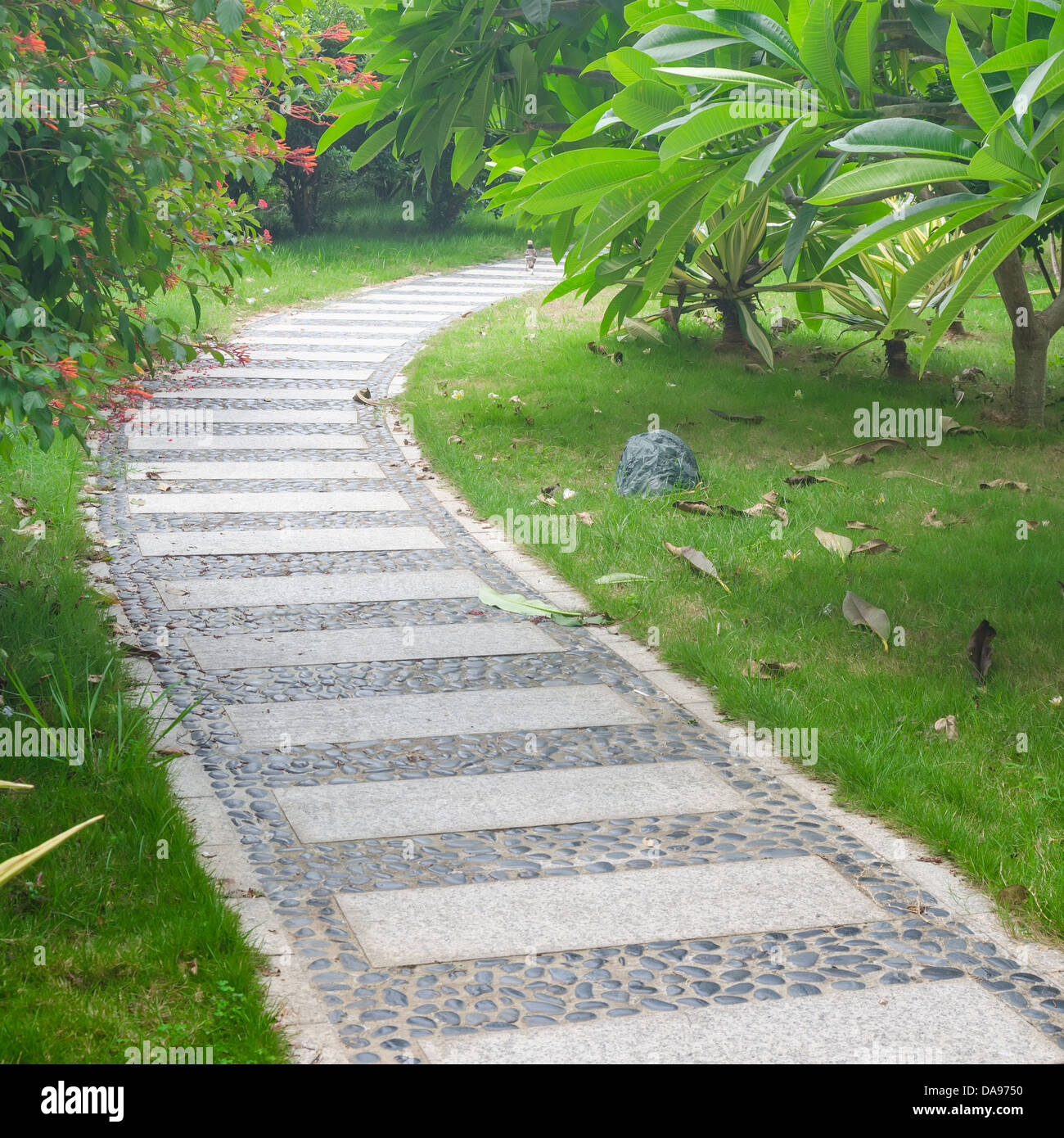 Bending garden stone path Stock Photo - Alamy