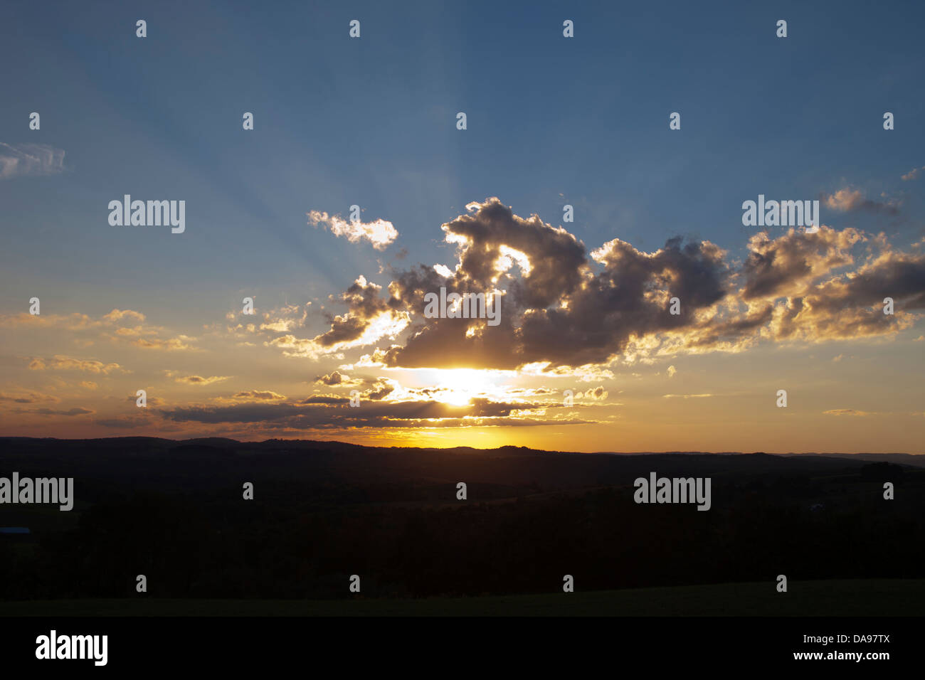 SUNSET OVER LAND Stock Photo - Alamy