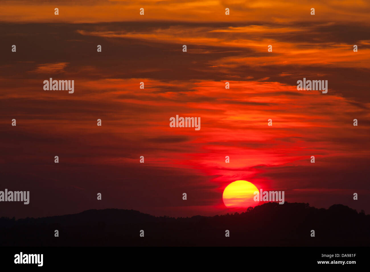 SUNSET OVER LAND Stock Photo - Alamy