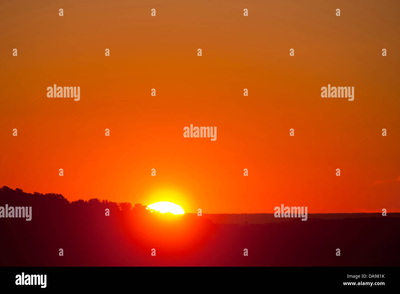SUNRISE OVER LAND Stock Photo - Alamy