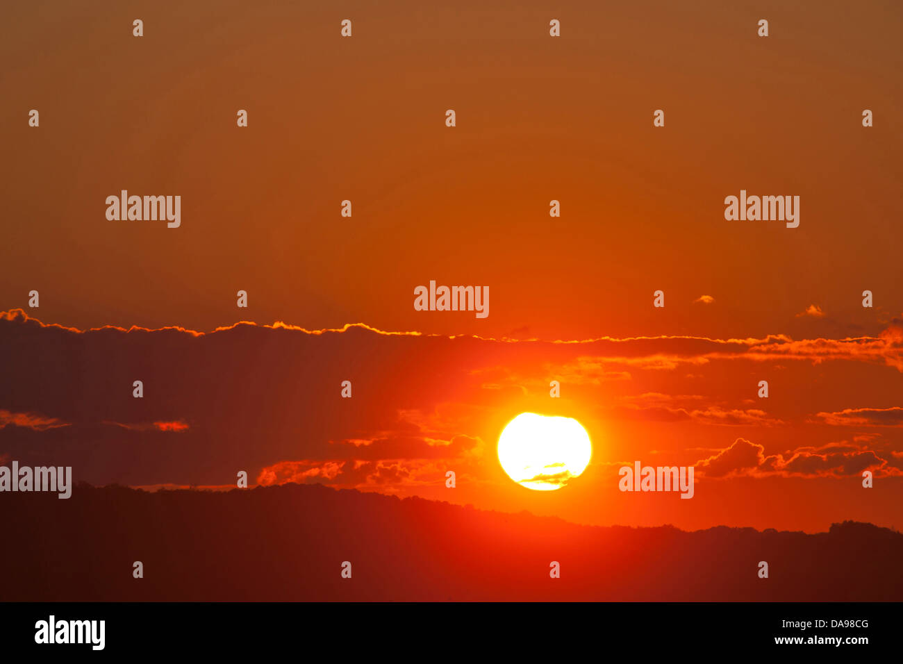 SUNSET CLOUDS OVER LAND Stock Photo - Alamy