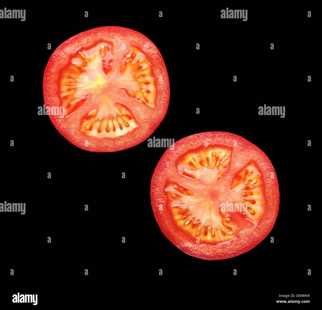 Two tomato sliced isolated on black Stock Photo - Alamy