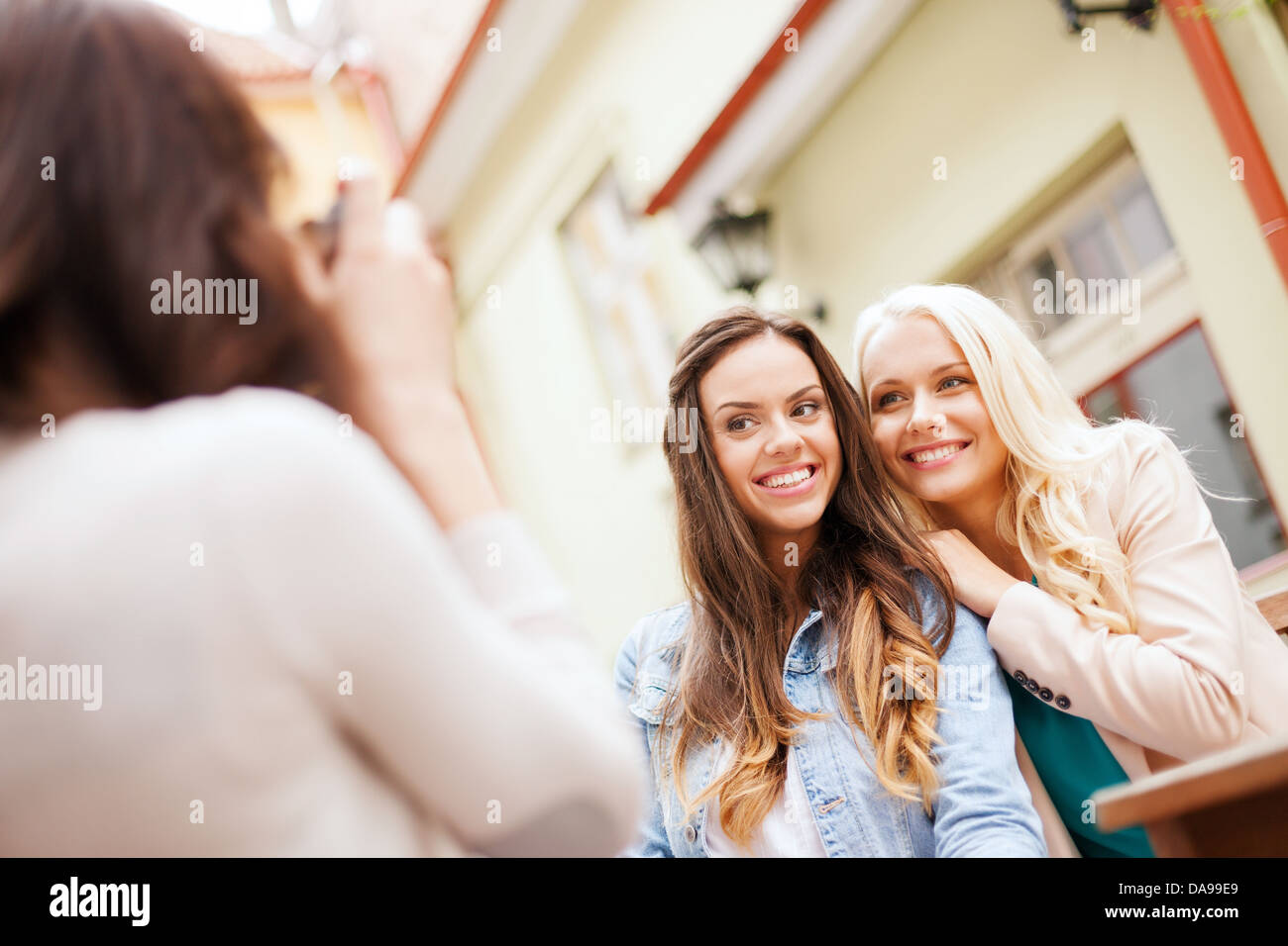 beautiful girls taking picture in cafe in city Stock Photo - Alamy