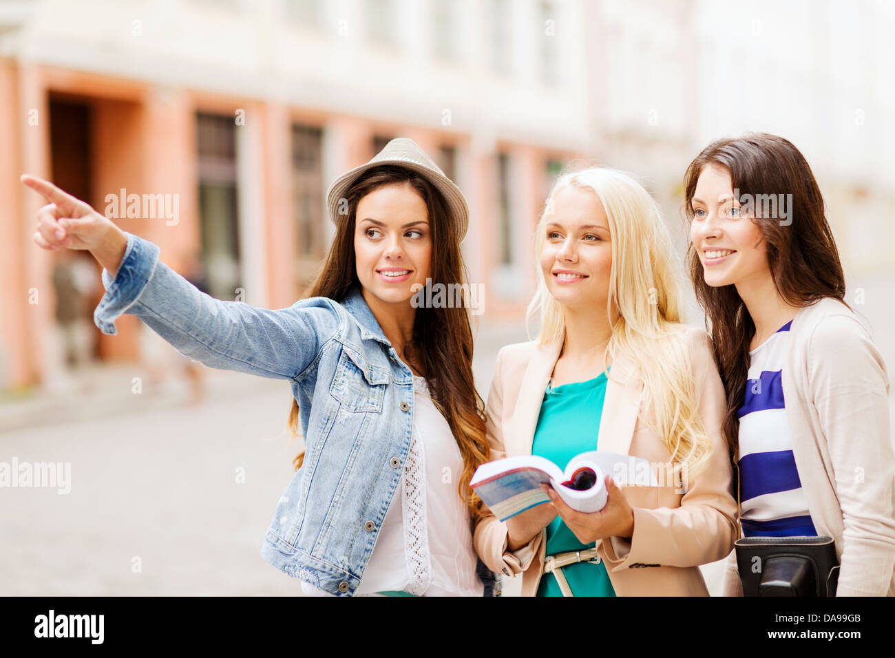 beautiful girls looking for direction in the city Stock Photo - Alamy