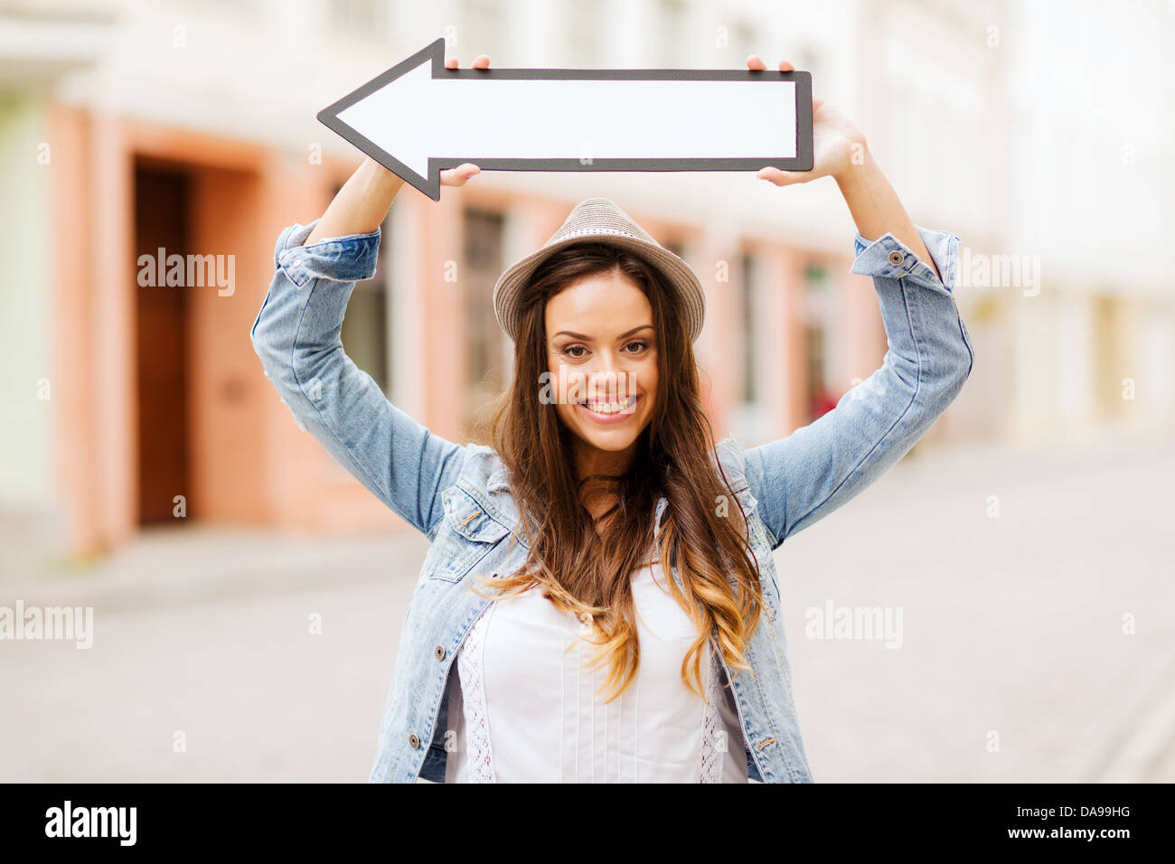 girl showing direction with arrow in the city Stock Photo - Alamy