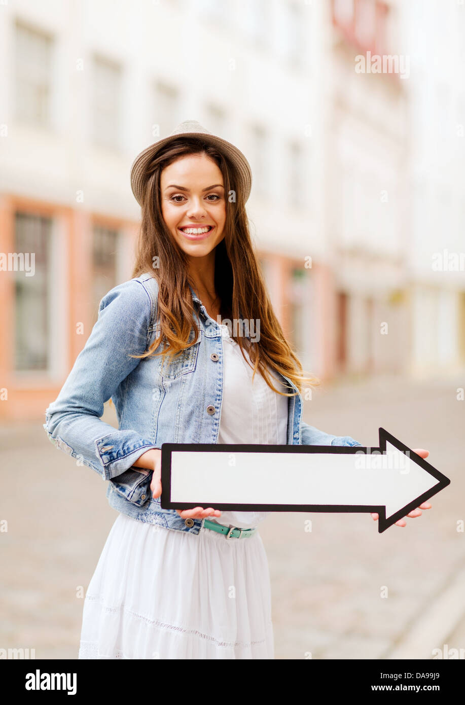 girl showing direction with arrow in the city Stock Photo - Alamy