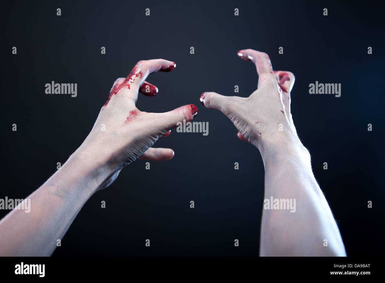 Grey skin bloody zombie hands, studio shot over gray background Stock ...